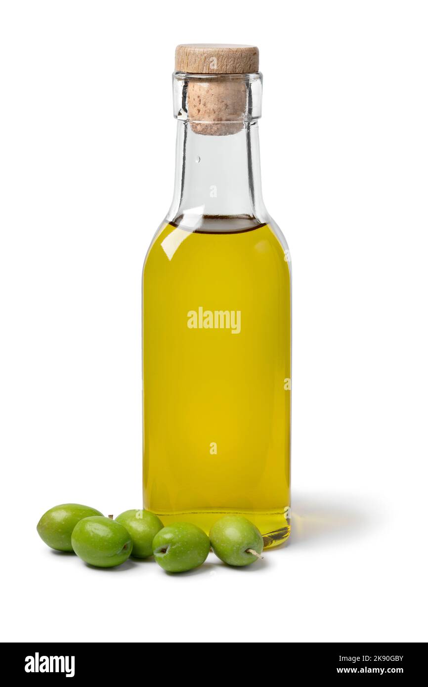 Bottle olive oil with a heap of fresh raw green olives in front isolated on white background ...