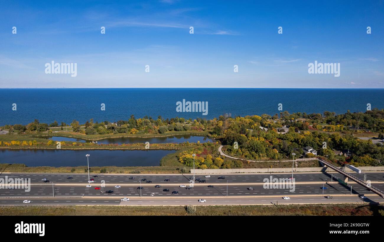 An aerial view of the blue sea, lakes and a busy highway under the ...