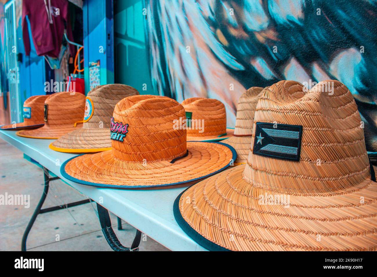 A closeup shot of straw hats with different signs in a souvenir shop in ...
