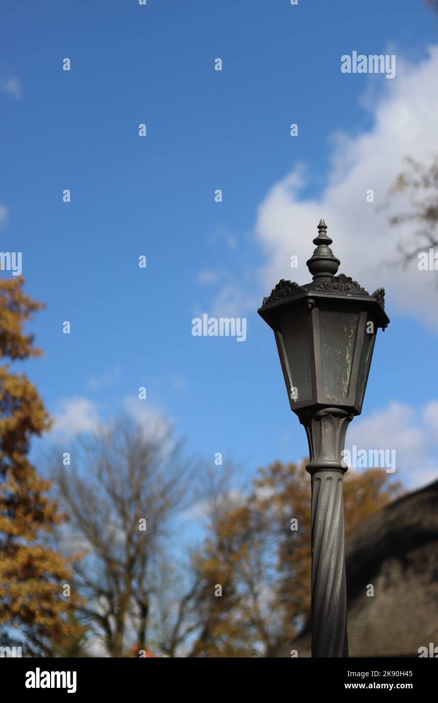 A fancy street light in the park, vertical Stock Photo - Alamy