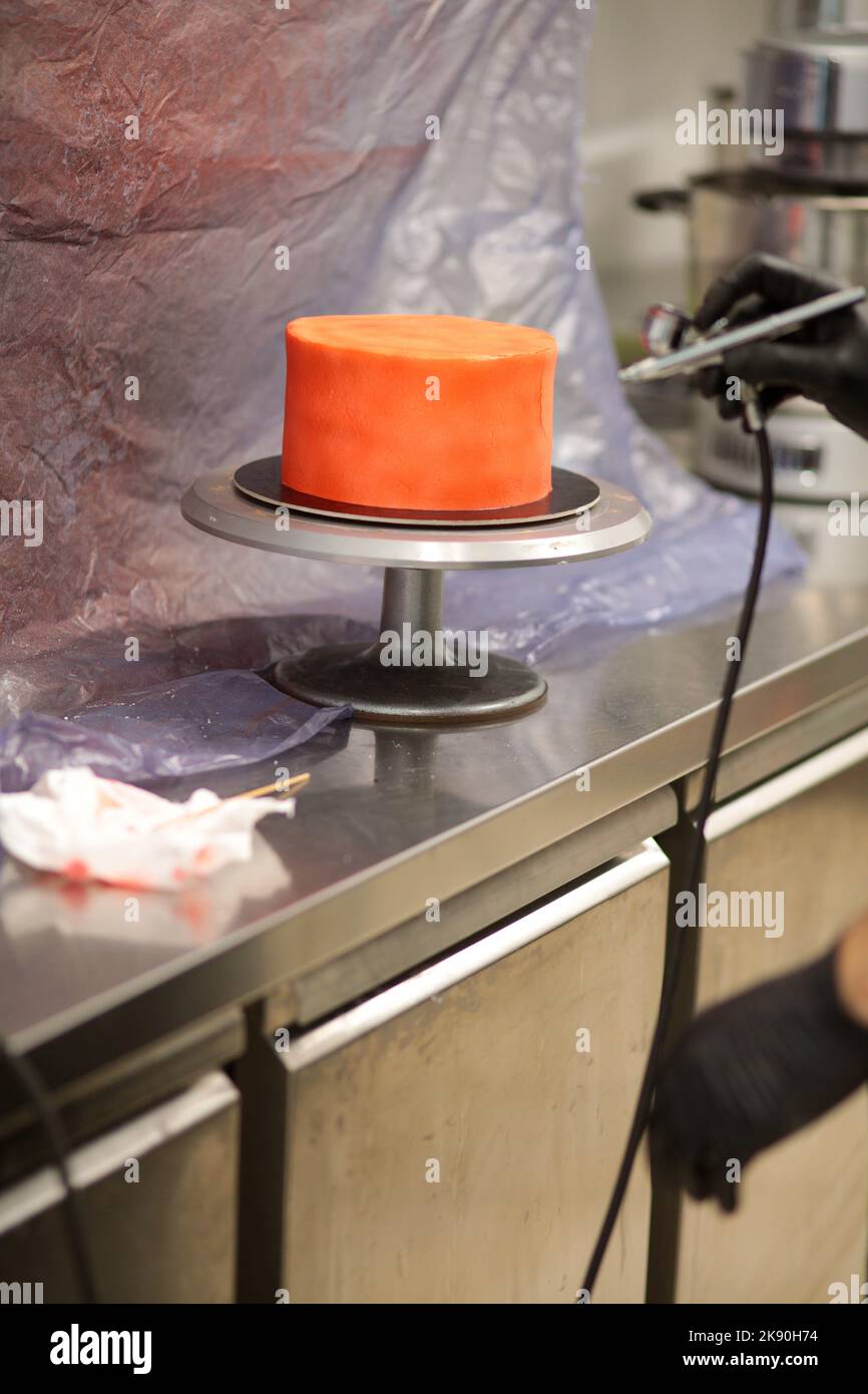 Baker preparing cake cream using hi-res stock photography and images ...