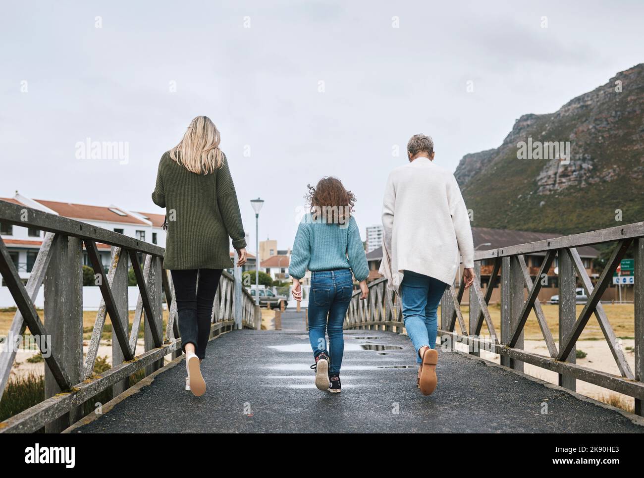 Family, walking and bridge in nature by mountain together on holiday ...
