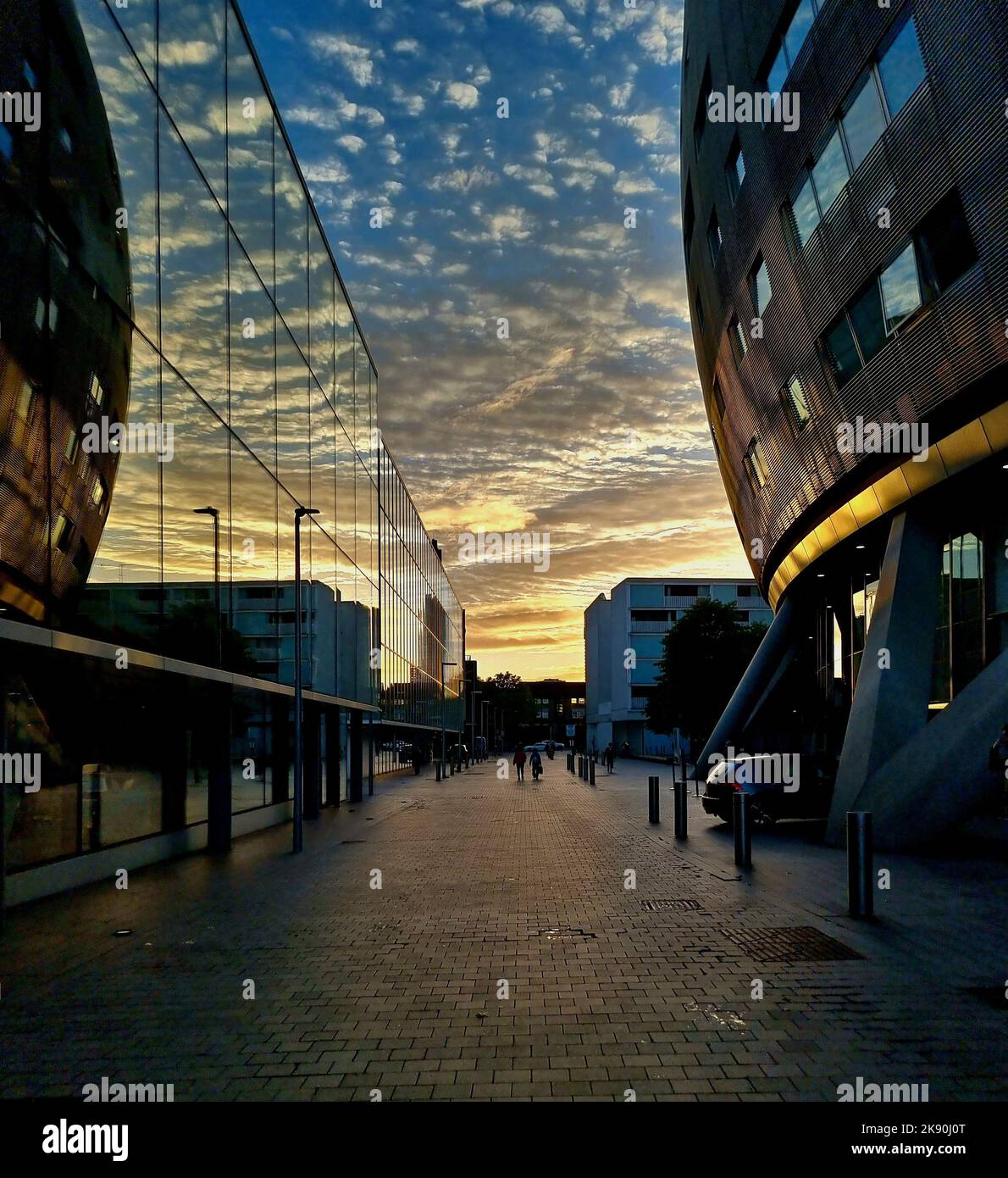 The beautiful view of sunset and sky reflected on the windows of modern ...