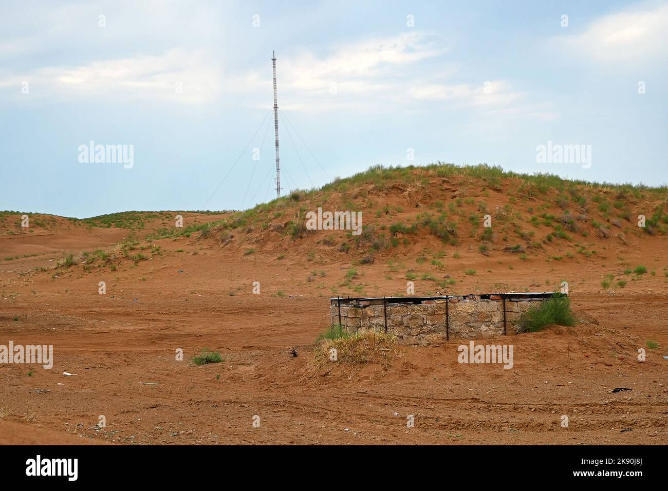 View of red Clay field, with communication tower and brick tank Stock ...