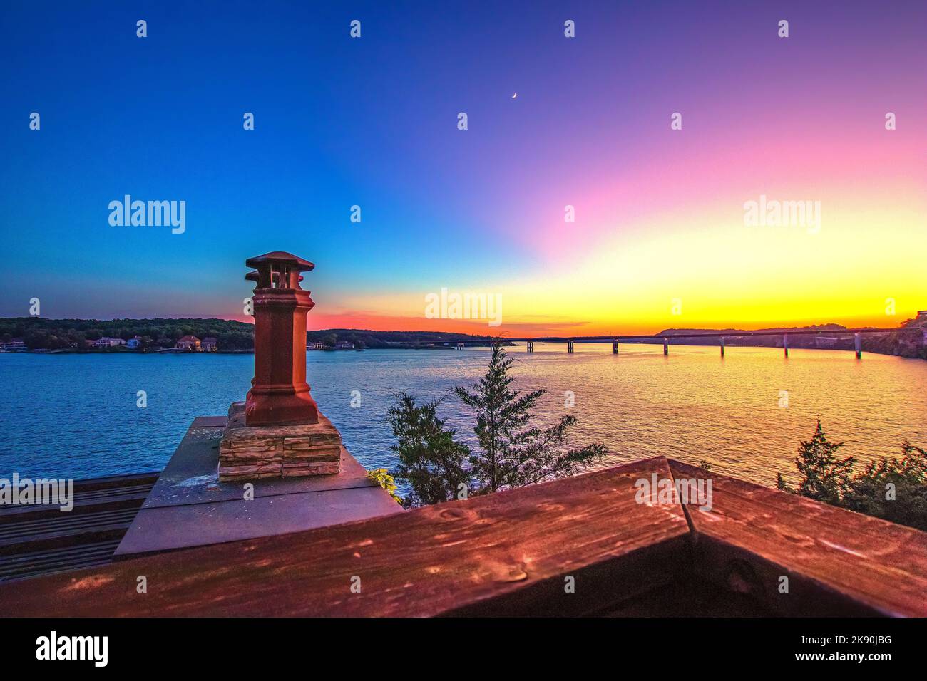 A dramatic sunset over a waterscape and a bridge Stock Photo - Alamy