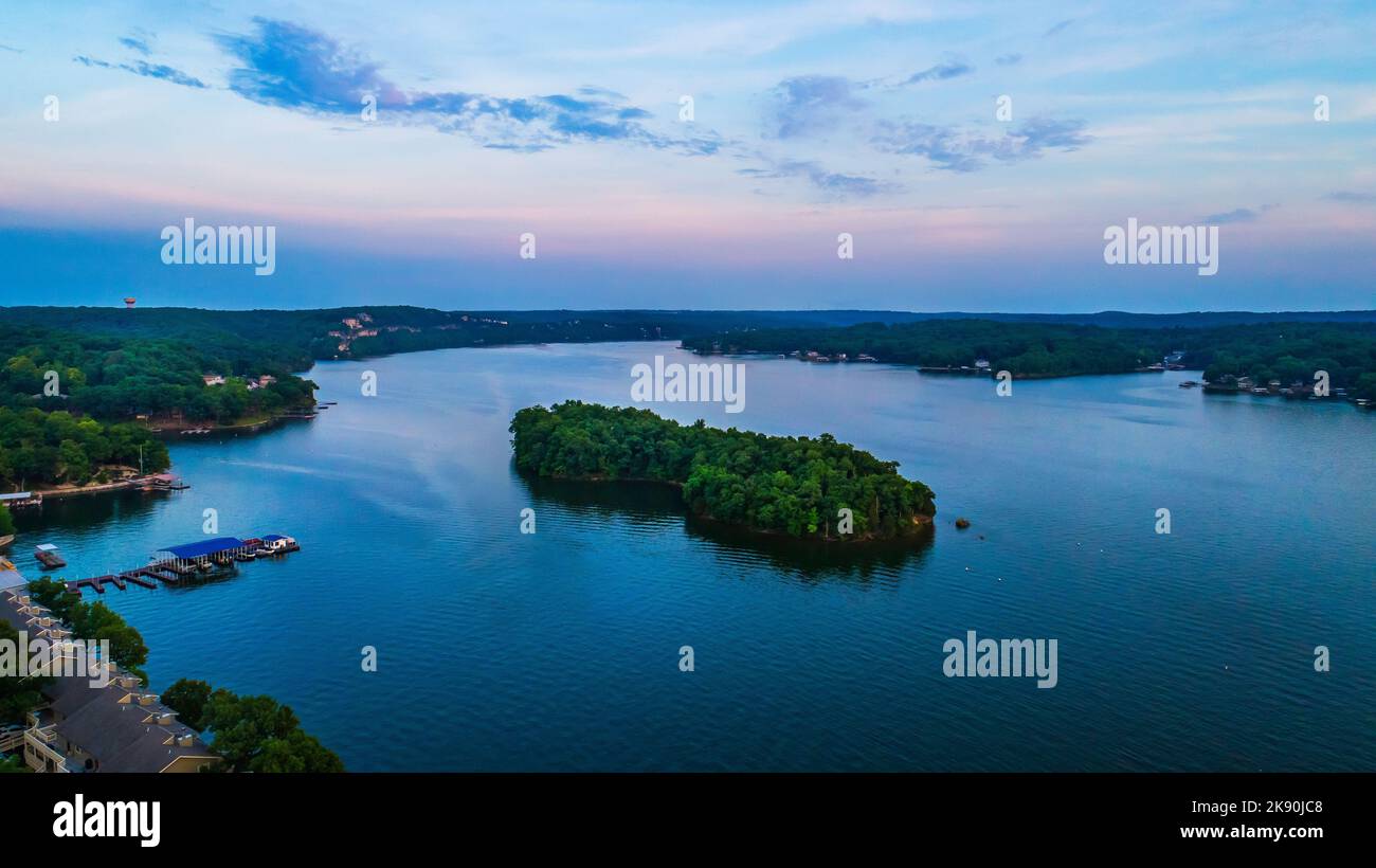 An aerial shot of a small island surrounded by a waterscape and ...