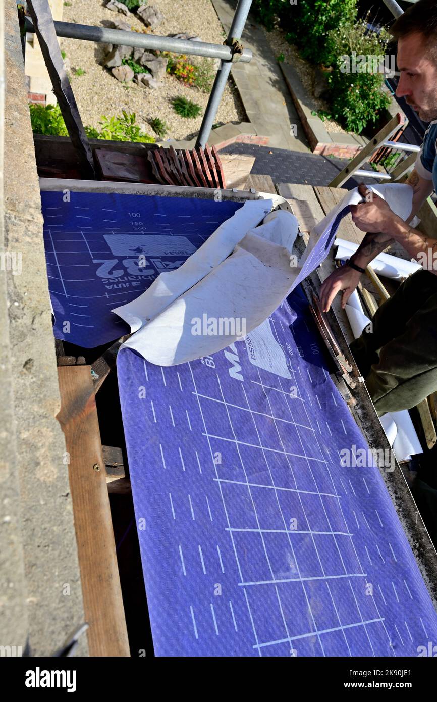 Roofing work on clay tiled residential hipped bay roof, fitting ...