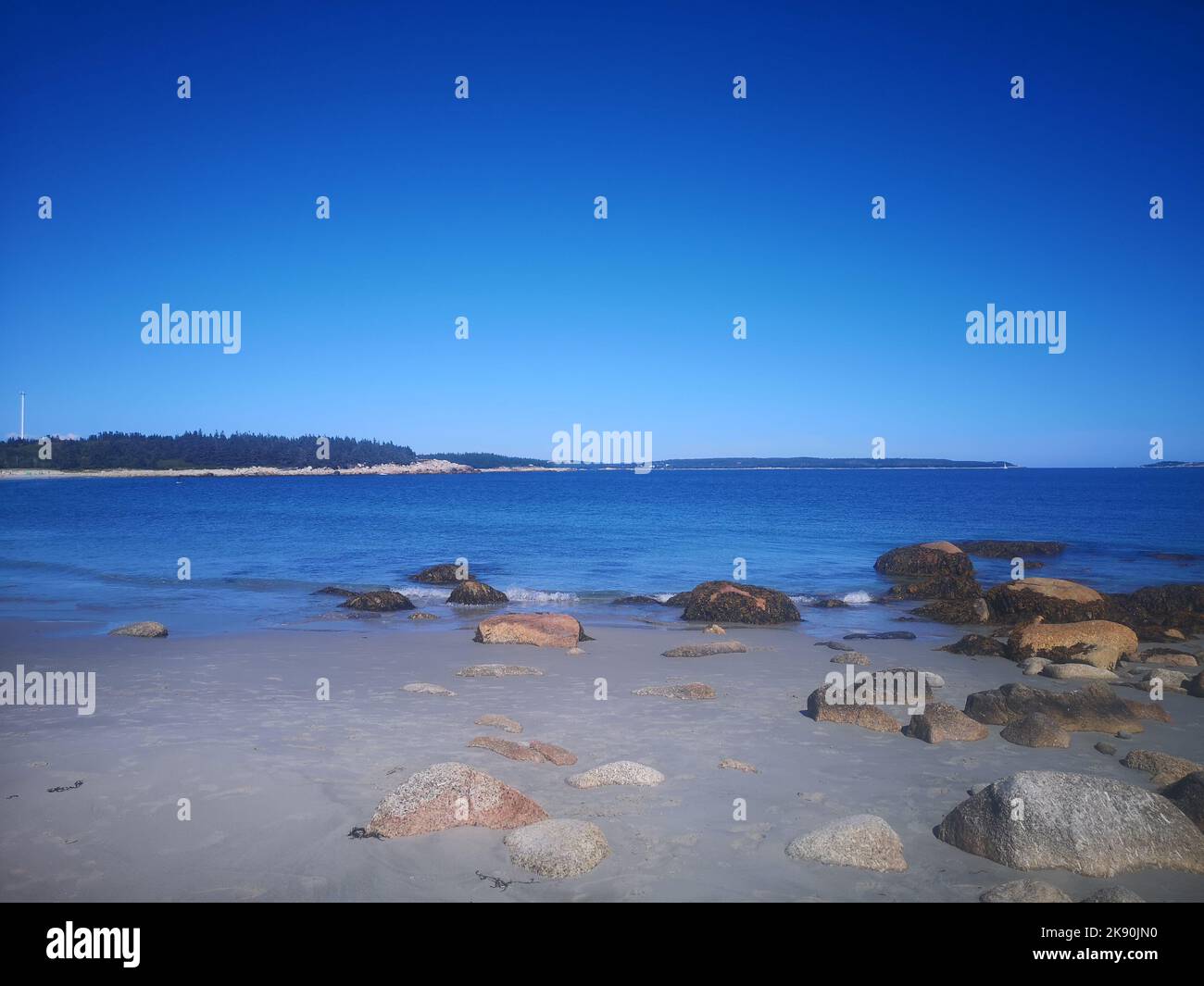 A scenic display of calm sea waves hitting the shoreline with big ...
