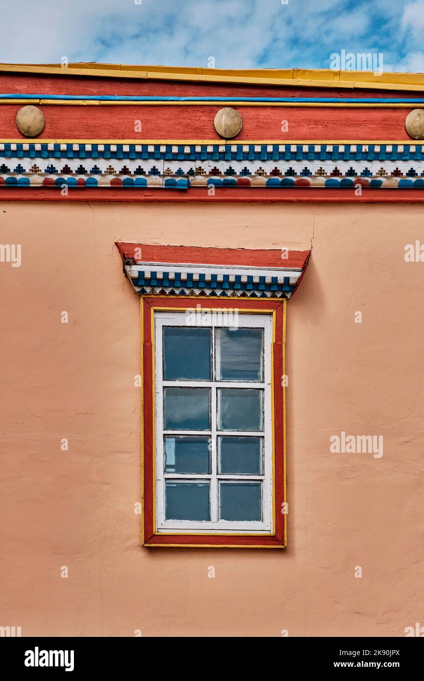Cornice, old wooden window with platbands, with traditional colorful ...