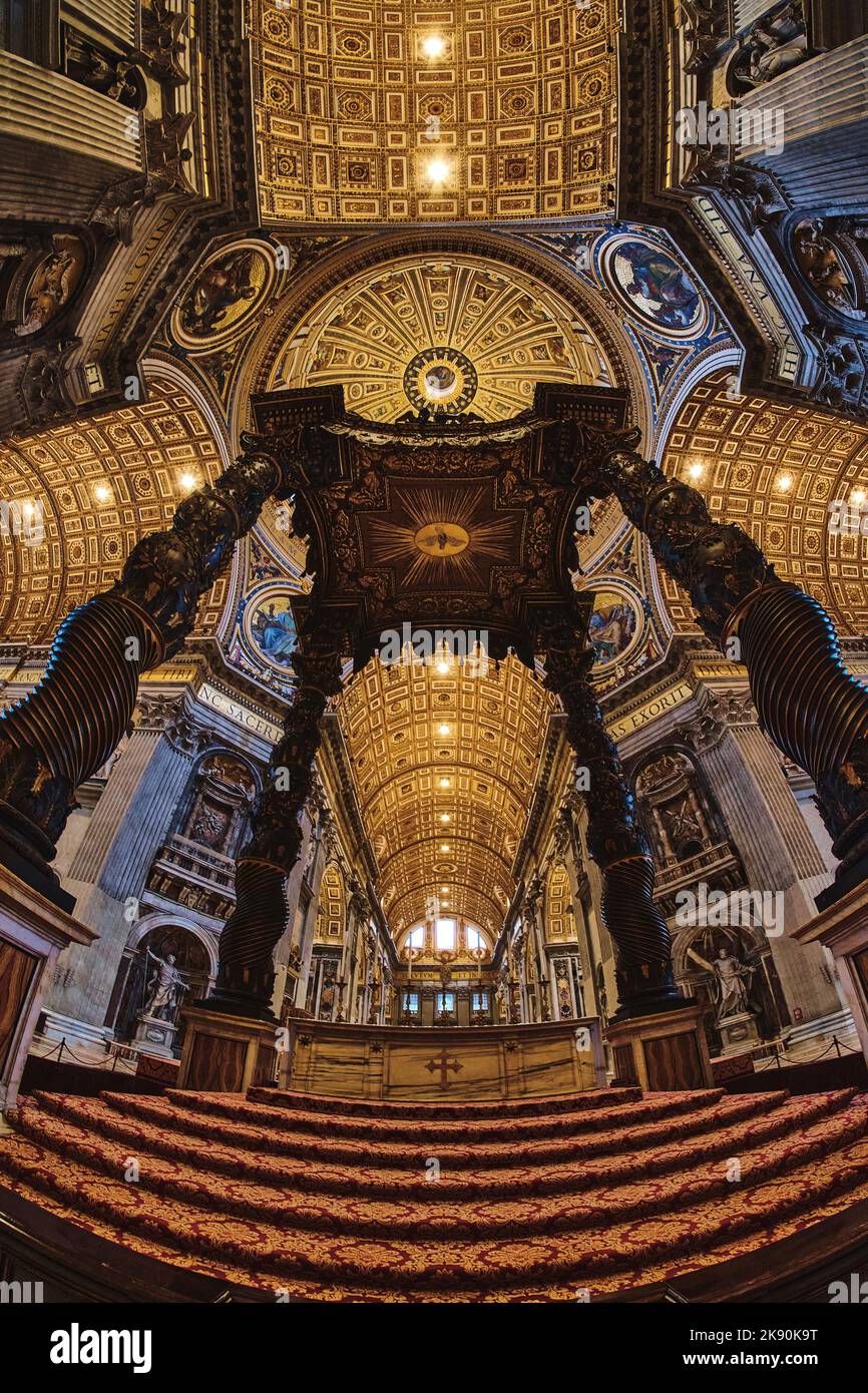 A vertical undershot of Saint Peter's Baldachin inside view with lights ...