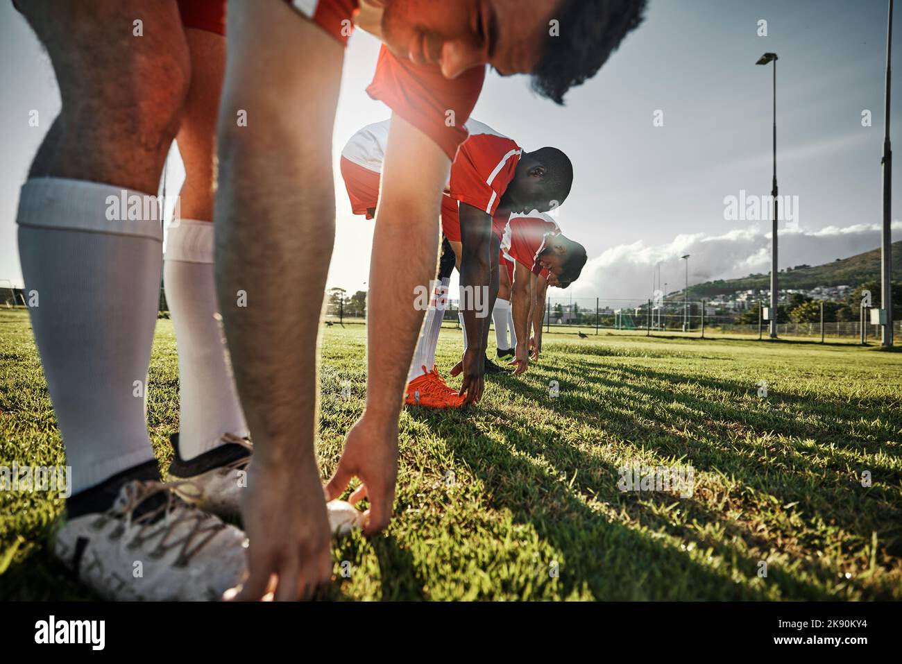 Soccer field, sports men and stretching legs on outdoor sports stadium ...