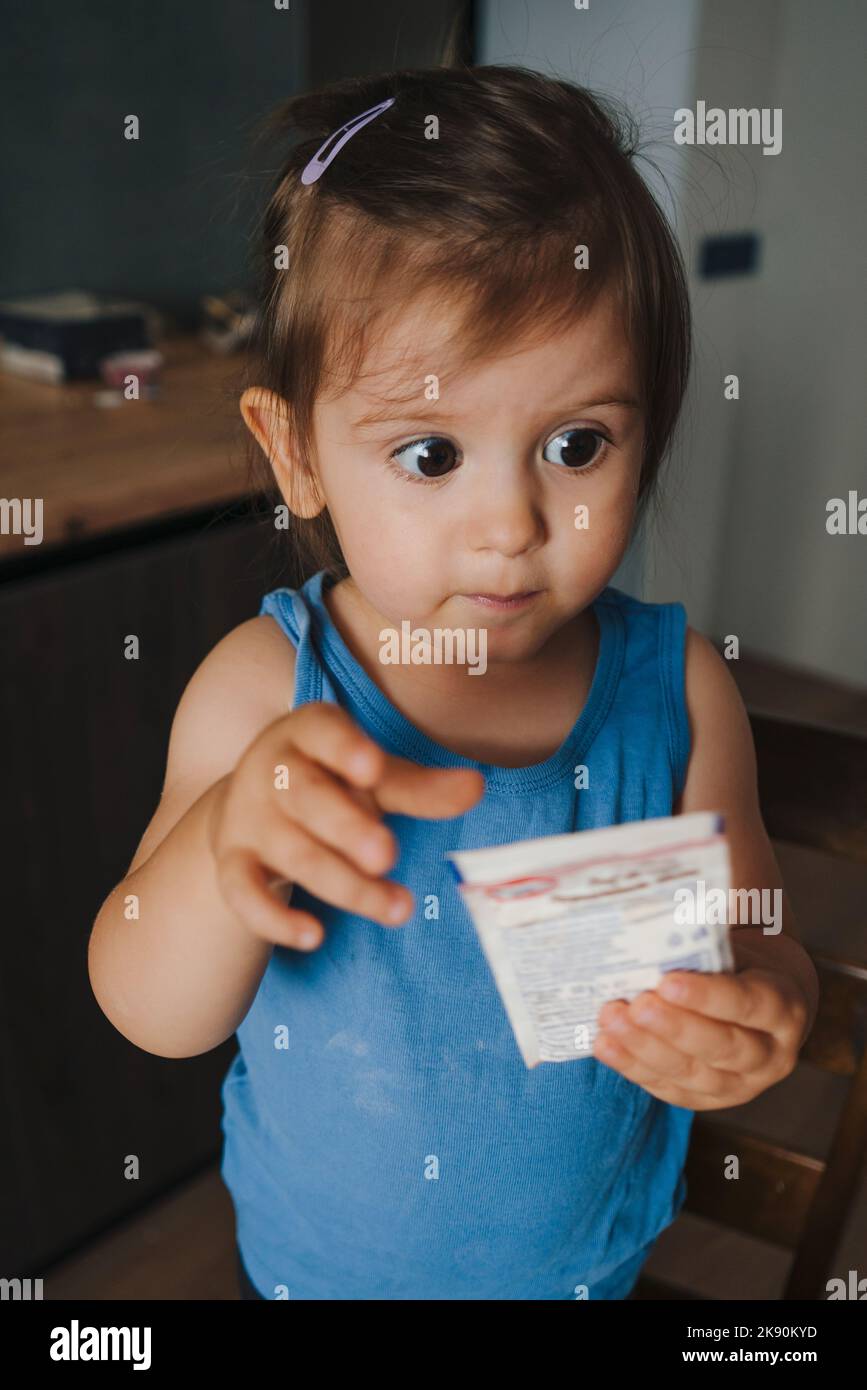 Portrait of an adorable little girl cooking something tasty together ...