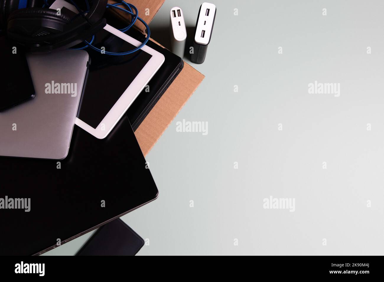 Cardboard box full of old used laptop computers, digital tablets ...