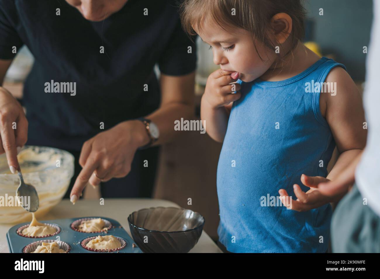 The baking tray full of colored paper forms that the mother and her ...