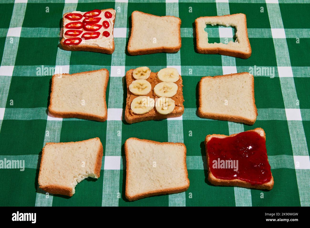 Fruit or jam. Original composition with uncooked bread toasts on plaid ...