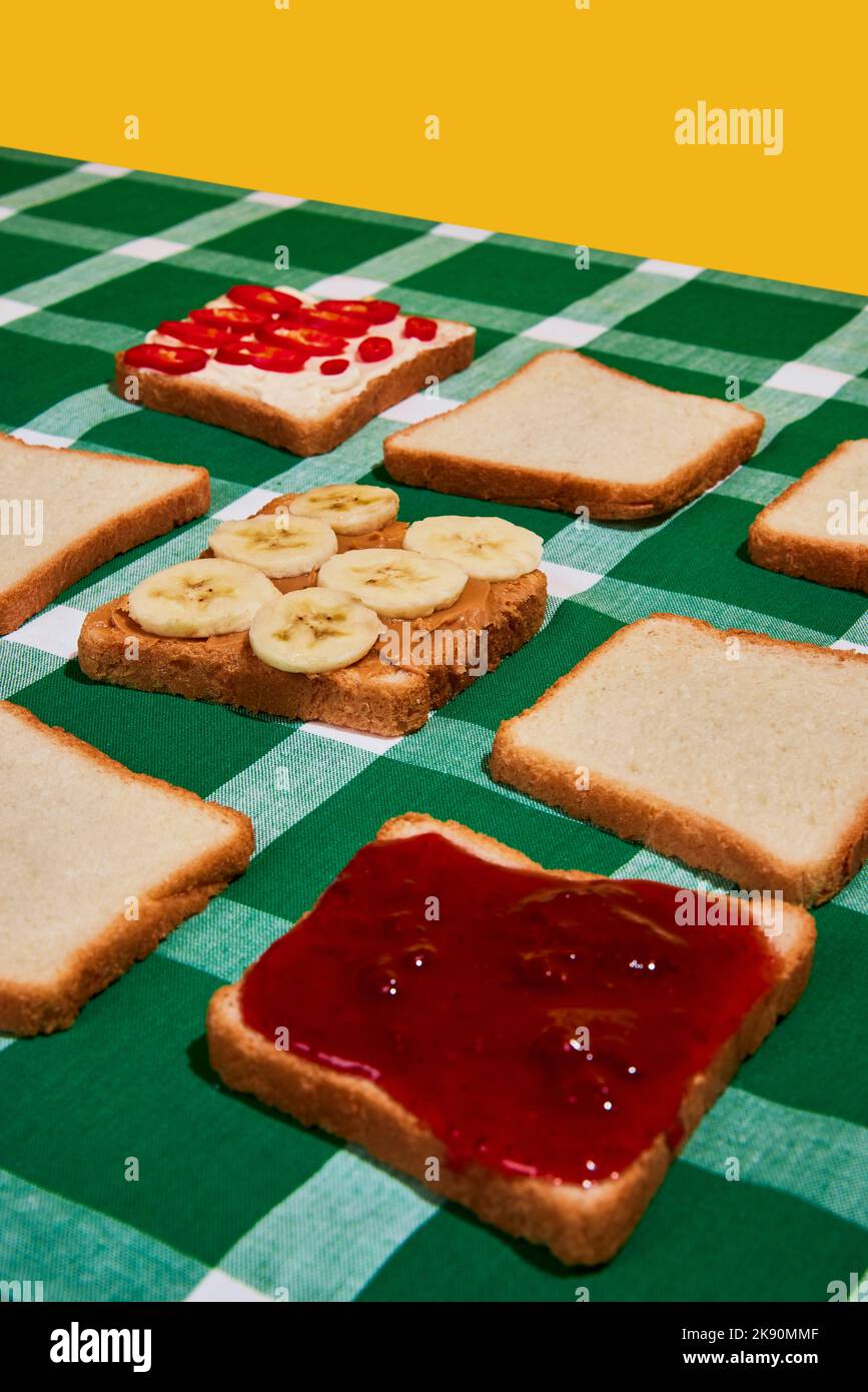Original composition with uncooked bread toasts on plaid green and ...