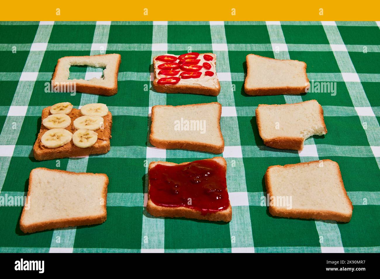 Original composition with uncooked bread toasts on plaid green and ...