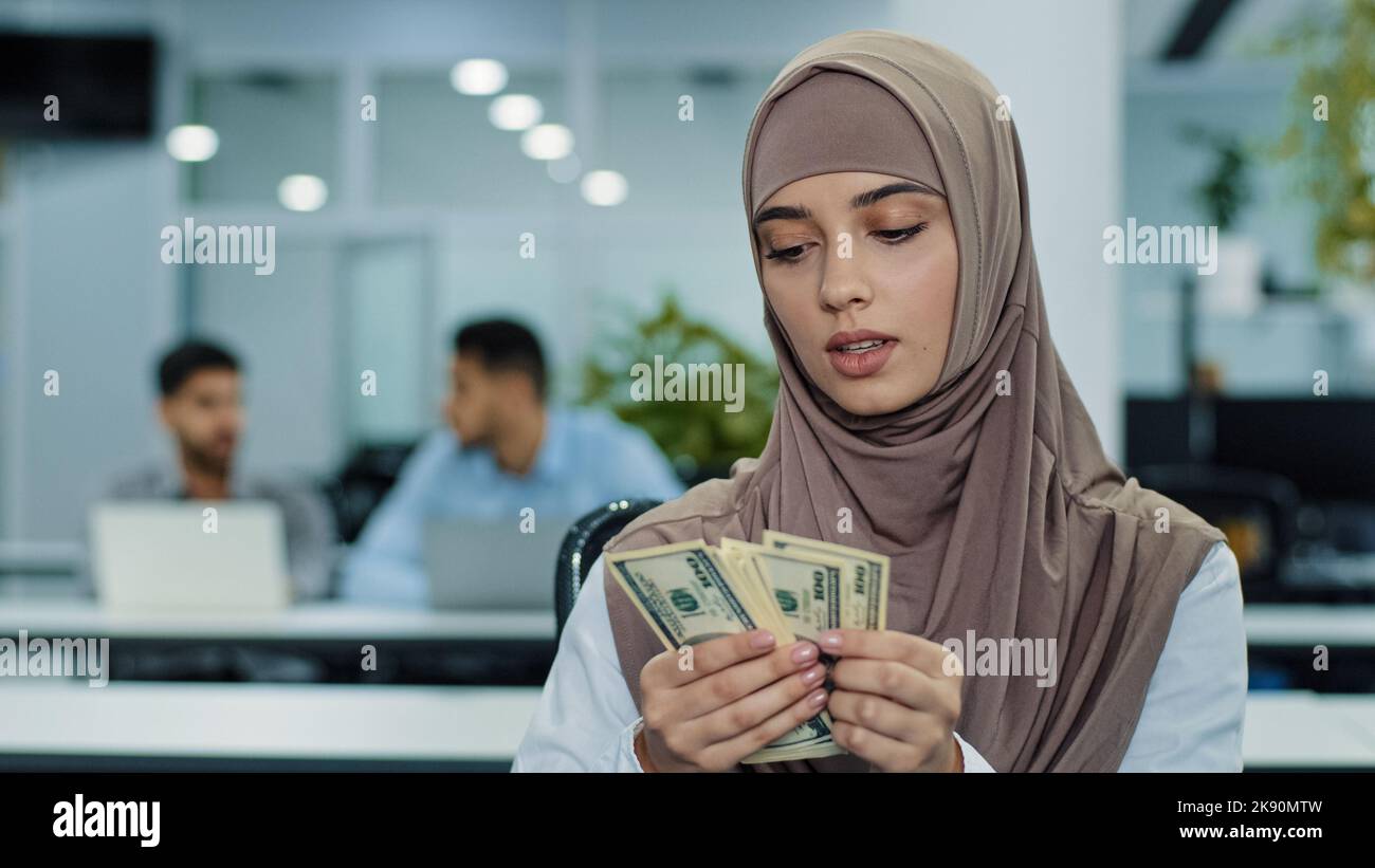 Serious concentrated eastern muslim girl in hijab office worker manager ...