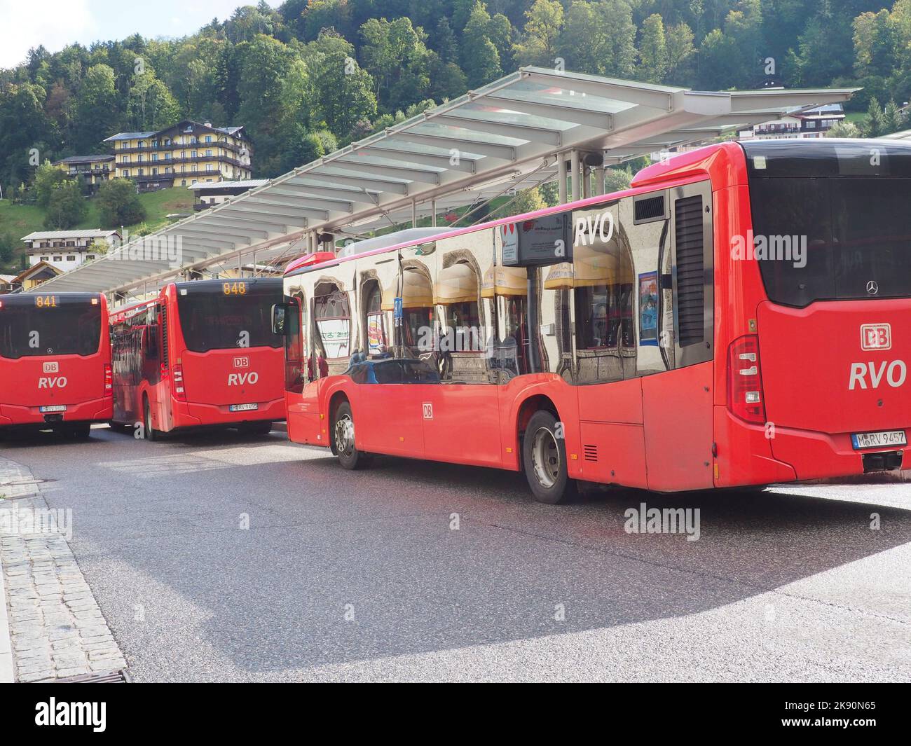 The red RVO Deutsche Bahn public buses waiting at a station in ...