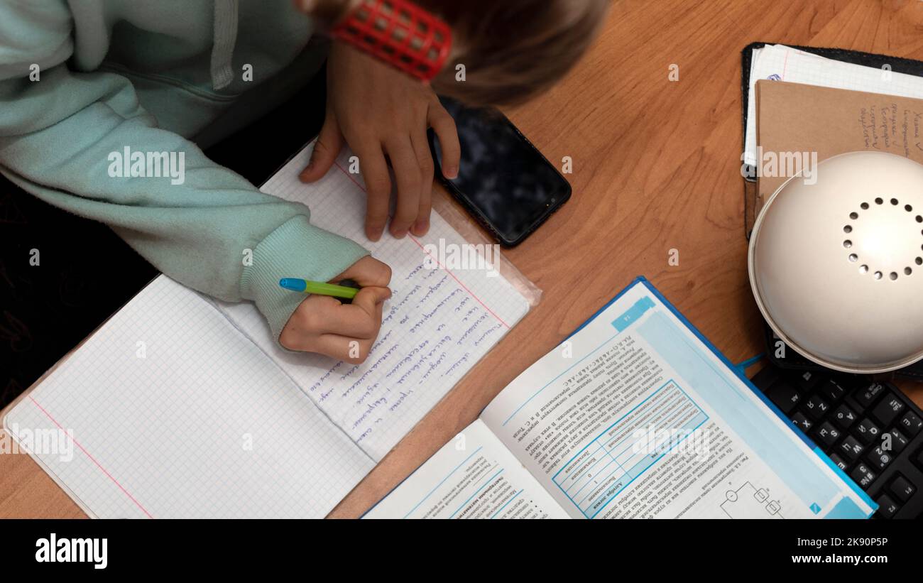 High school or college female student in curlers studying and reading ...