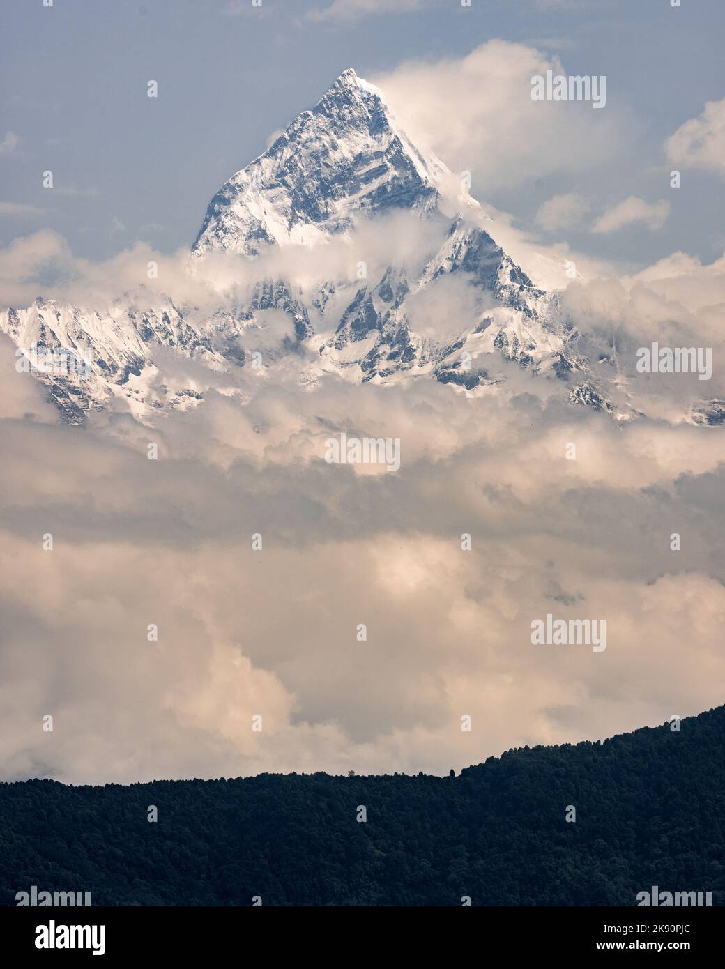The Machapuchare AKA Fishtail Mountain snowy peak covered with clouds ...