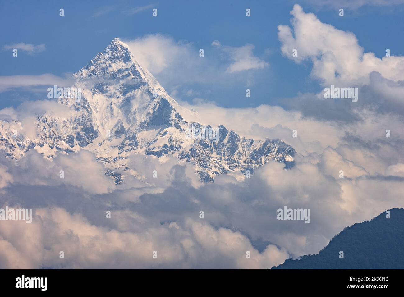 The Machapuchare AKA Fishtail Mountain snowy peak covered with clouds, Himalaya Range, Nepal ...