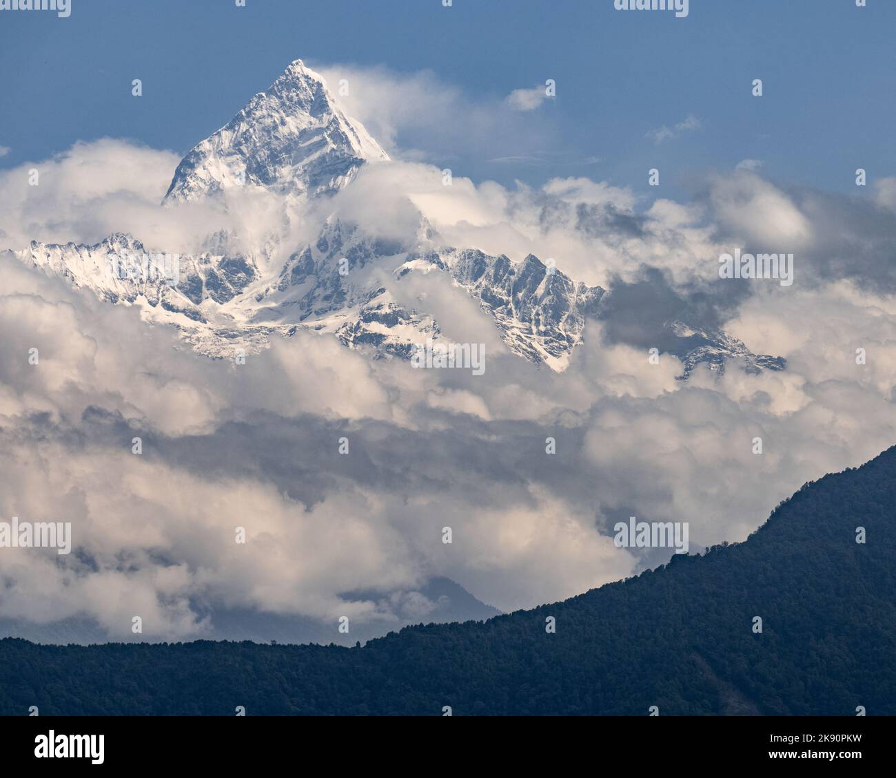 The Machapuchare AKA Fishtail Mountain snowy peak covered with clouds, Himalaya Range, Nepal ...