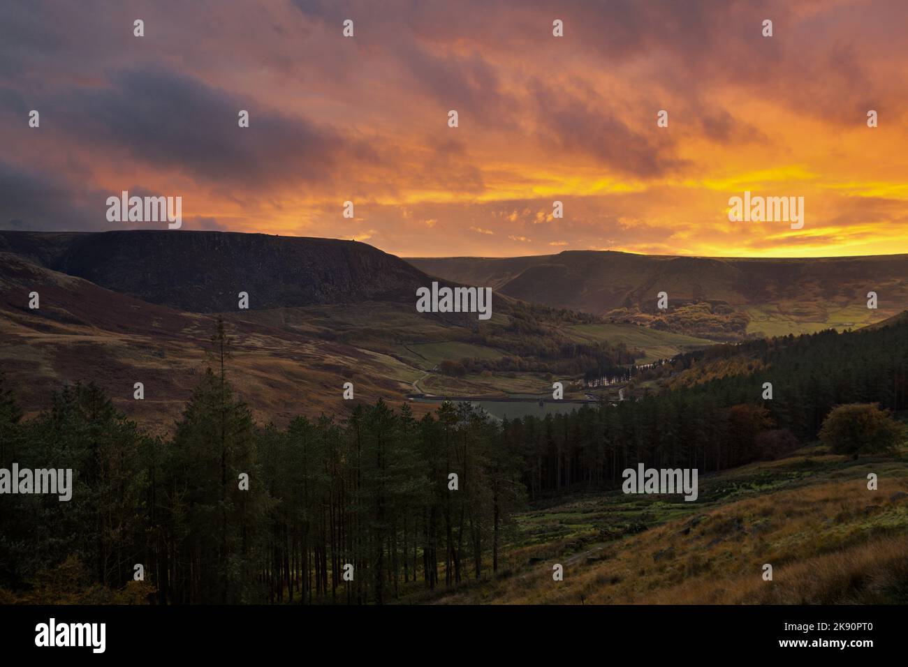 An orange sunset at Dovestone Reservoir near the village of Greenfield ...