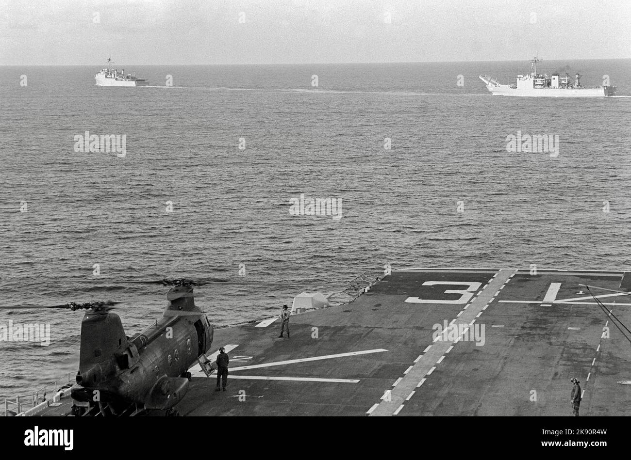 A CH-46 Sea Knight helicopter prepares to take off from the flight deck ...