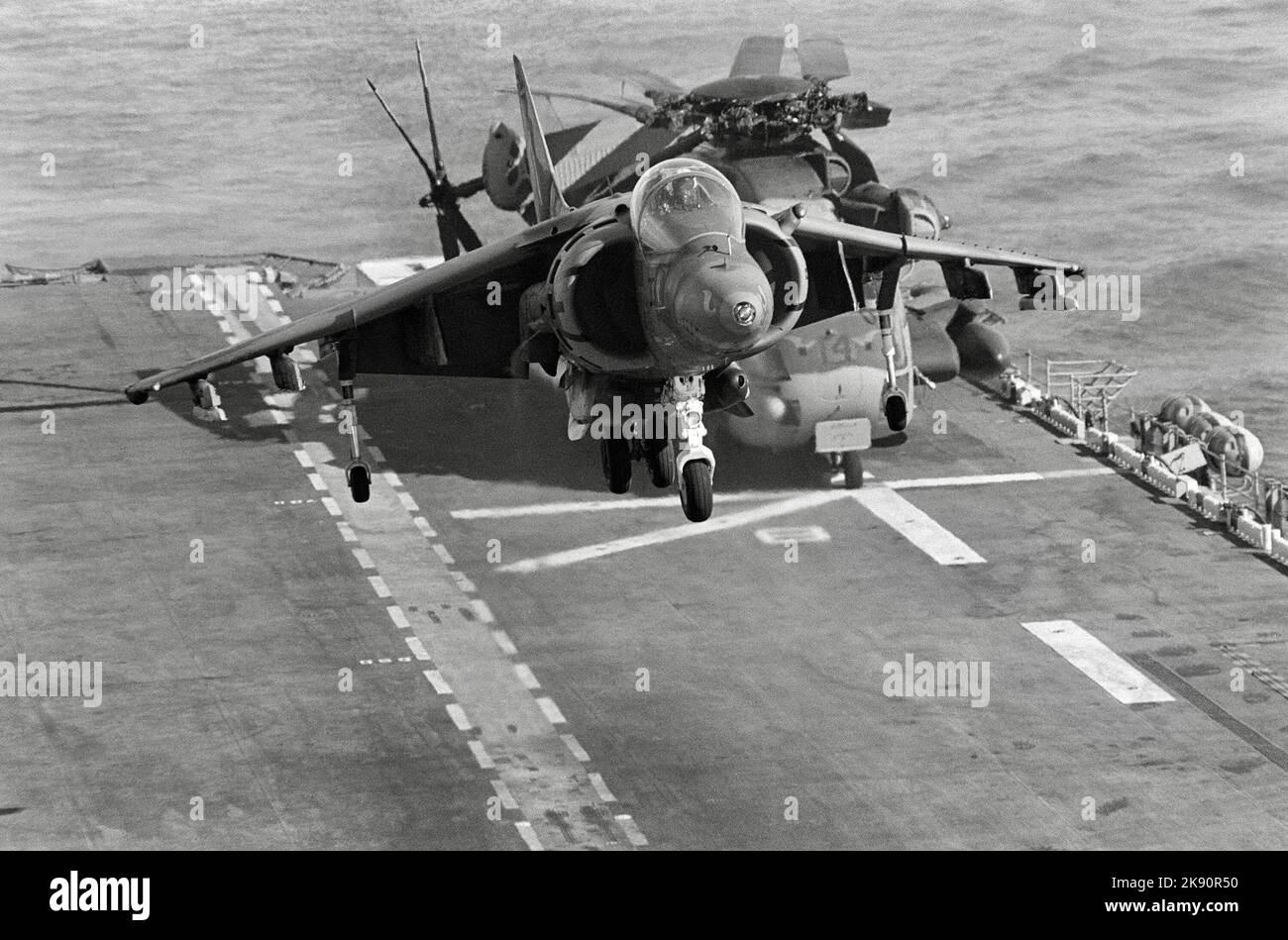 An AV-8B Harrier aircraft prepares to land aboard the amphibious ...