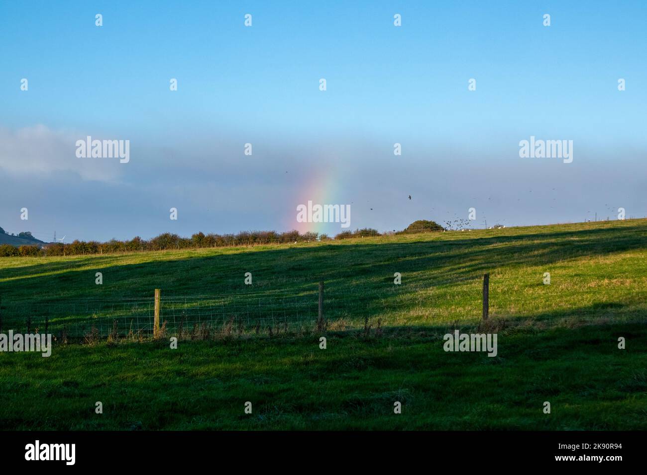 Rainbow over fields in autumn sunshine Stock Photo - Alamy