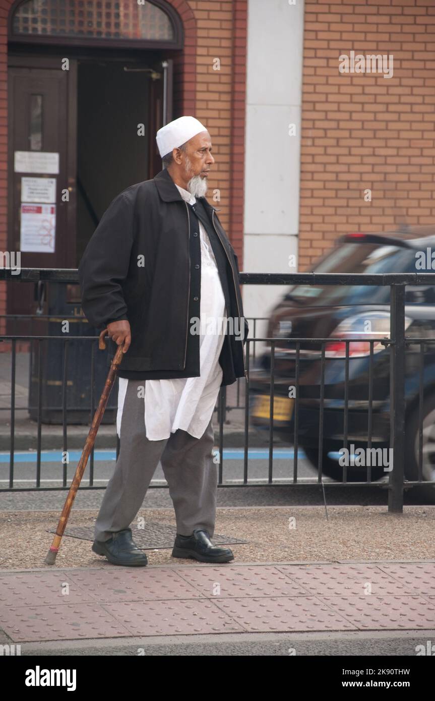Man with Arabic Scullcap walking along Whitechapel, Tower Hamlets, East ...