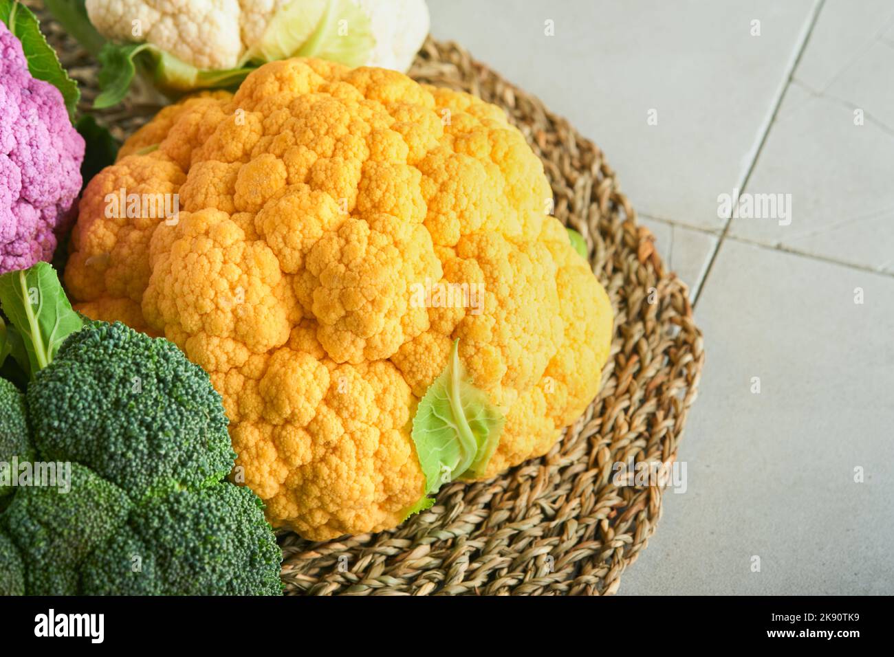 Colorfu cauliflower. Various sort of cauliflower on stone tiles gray ...