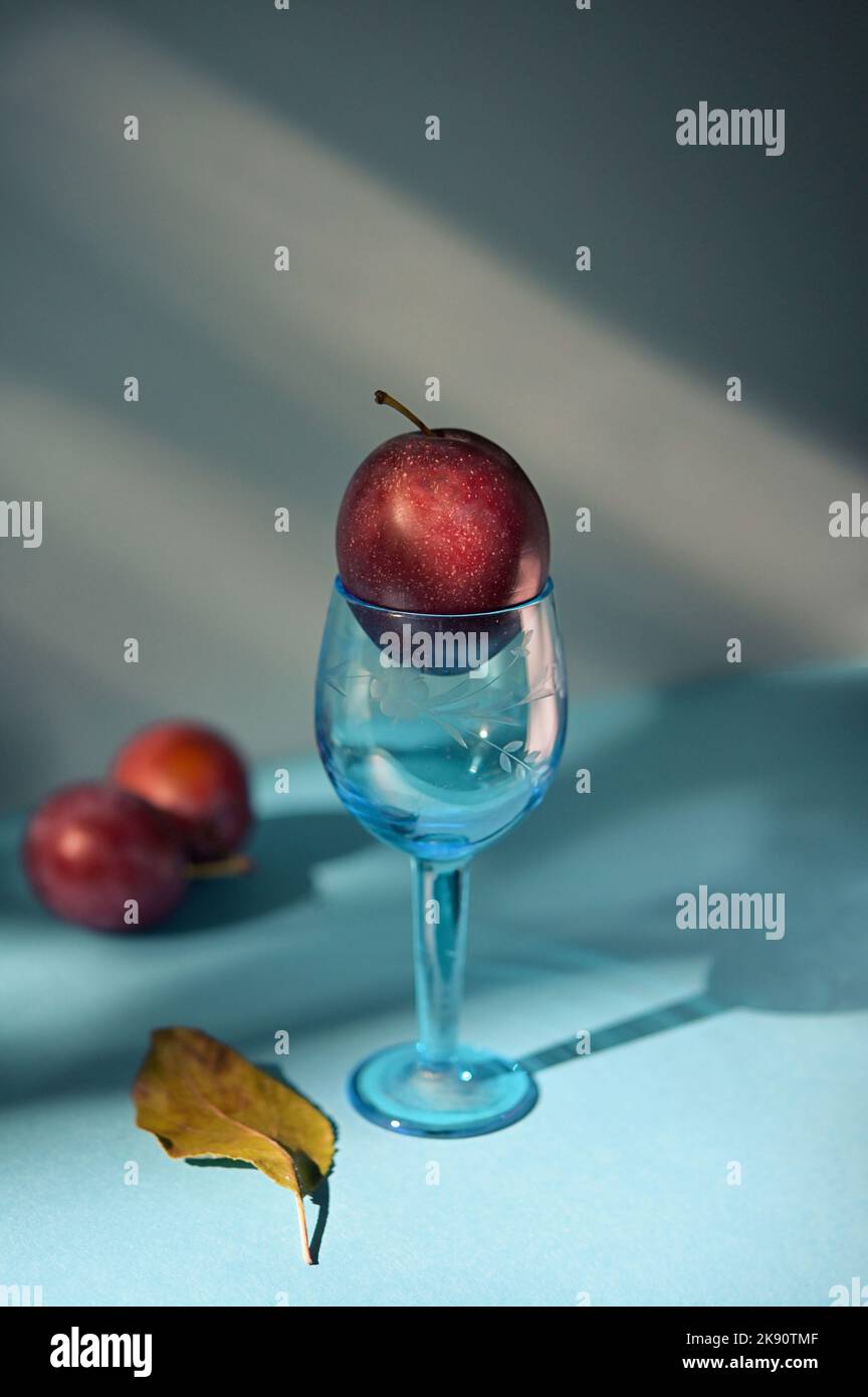 Abstract Ripe plums in small glass shoot in studio Stock Photo - Alamy