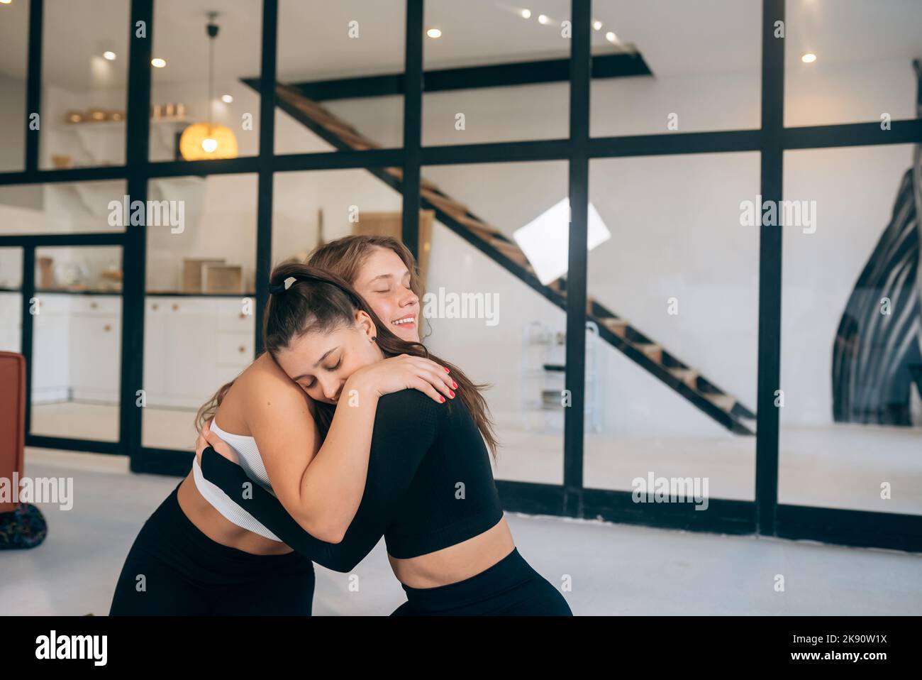 Two girlfriends hug each other after yoga Stock Photo - Alamy