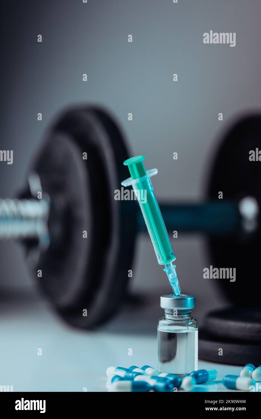 A vertical shot of pharmaceutical syringe with needle in a medicine and ...