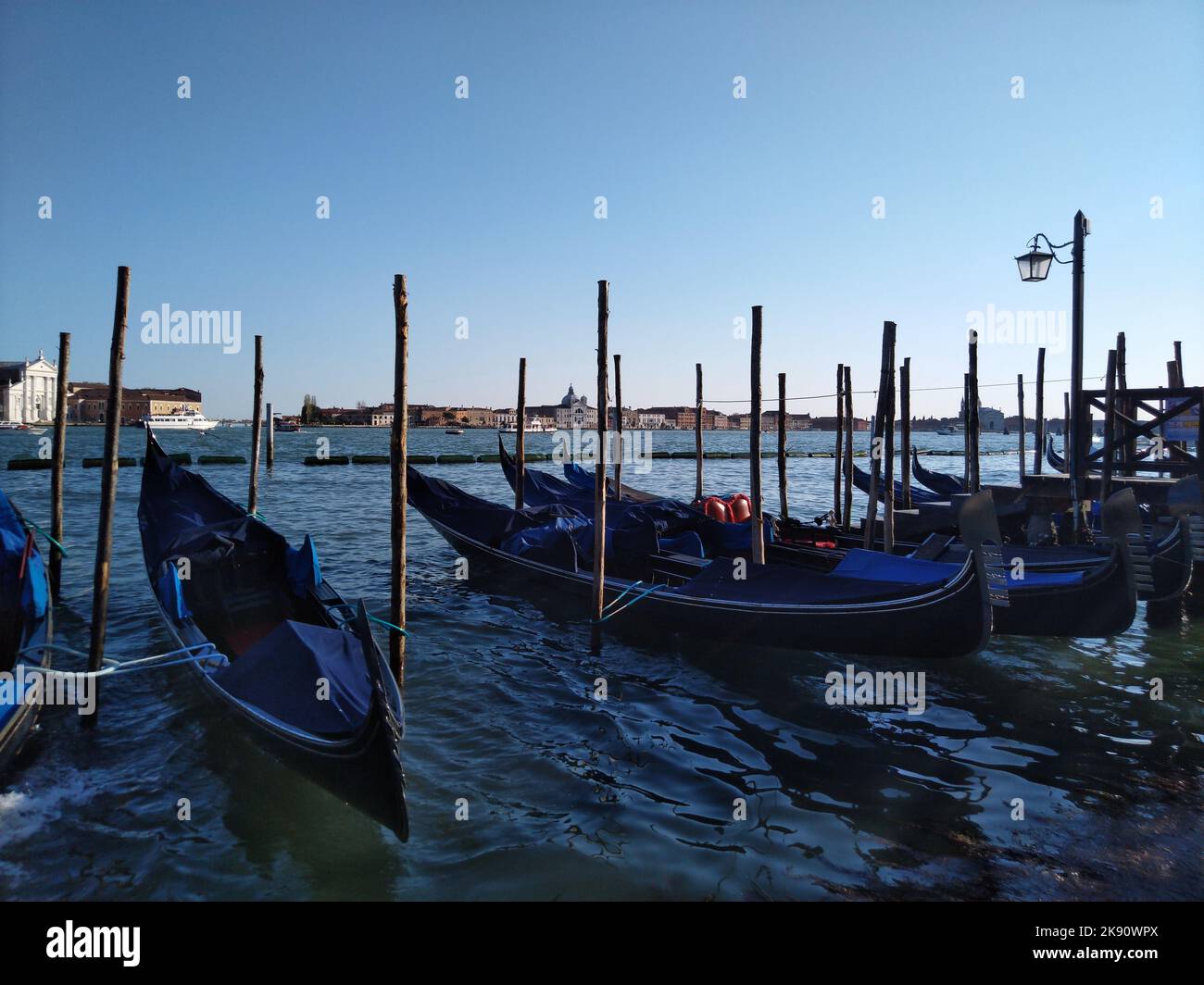 Row of blue gondolas moored at pier hi-res stock photography and images ...