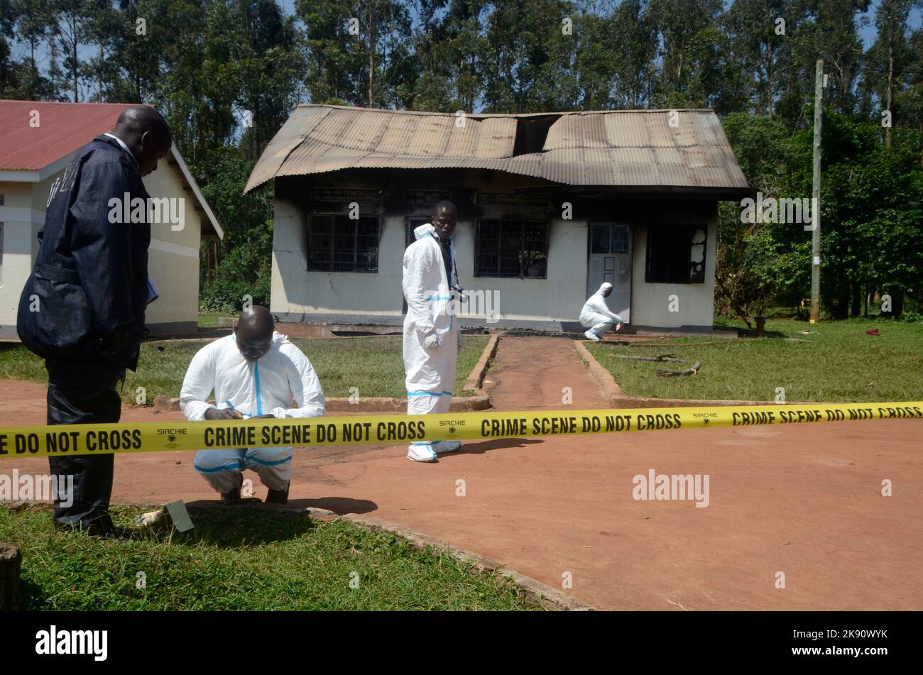 Mukono, Uganda. 25th Oct, 2022. Fire forensic experts collect evidence ...