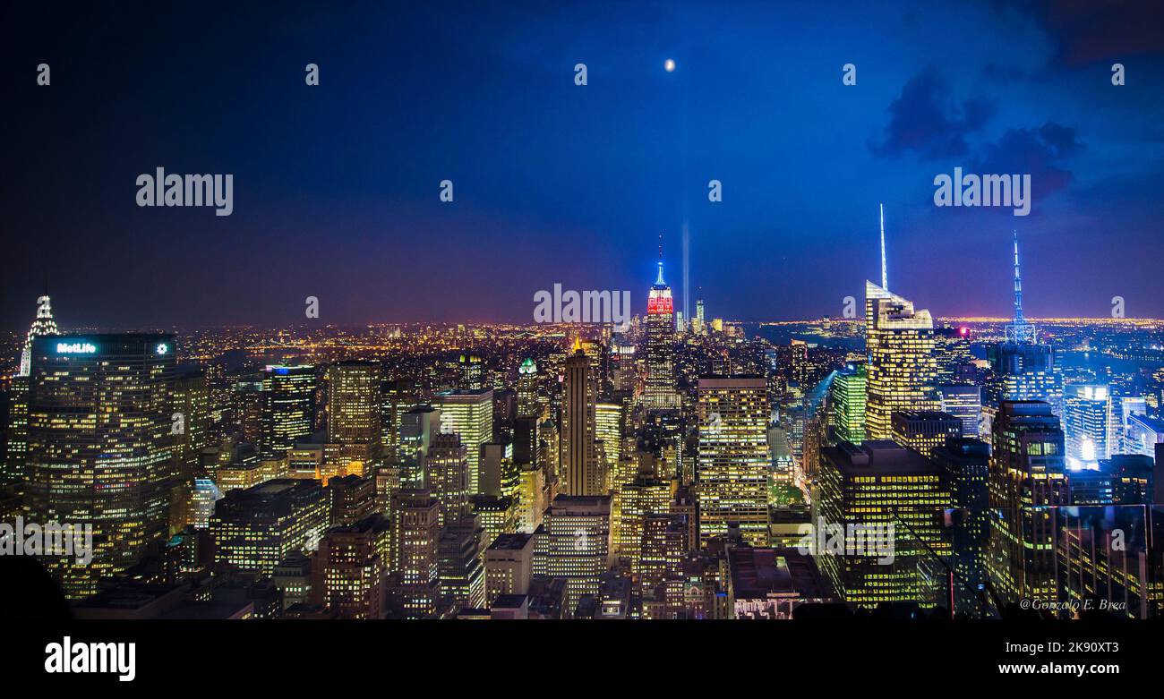 An aerial view of the illuminated buildings of an urban cityscape under ...