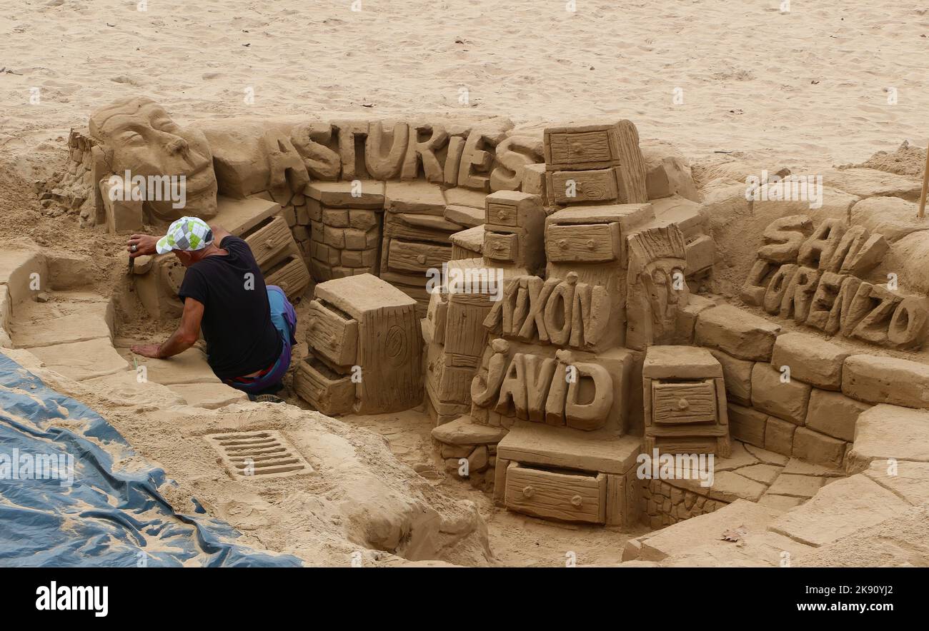 Sand sculptor working creating chests of drawers on the beach Playa de ...