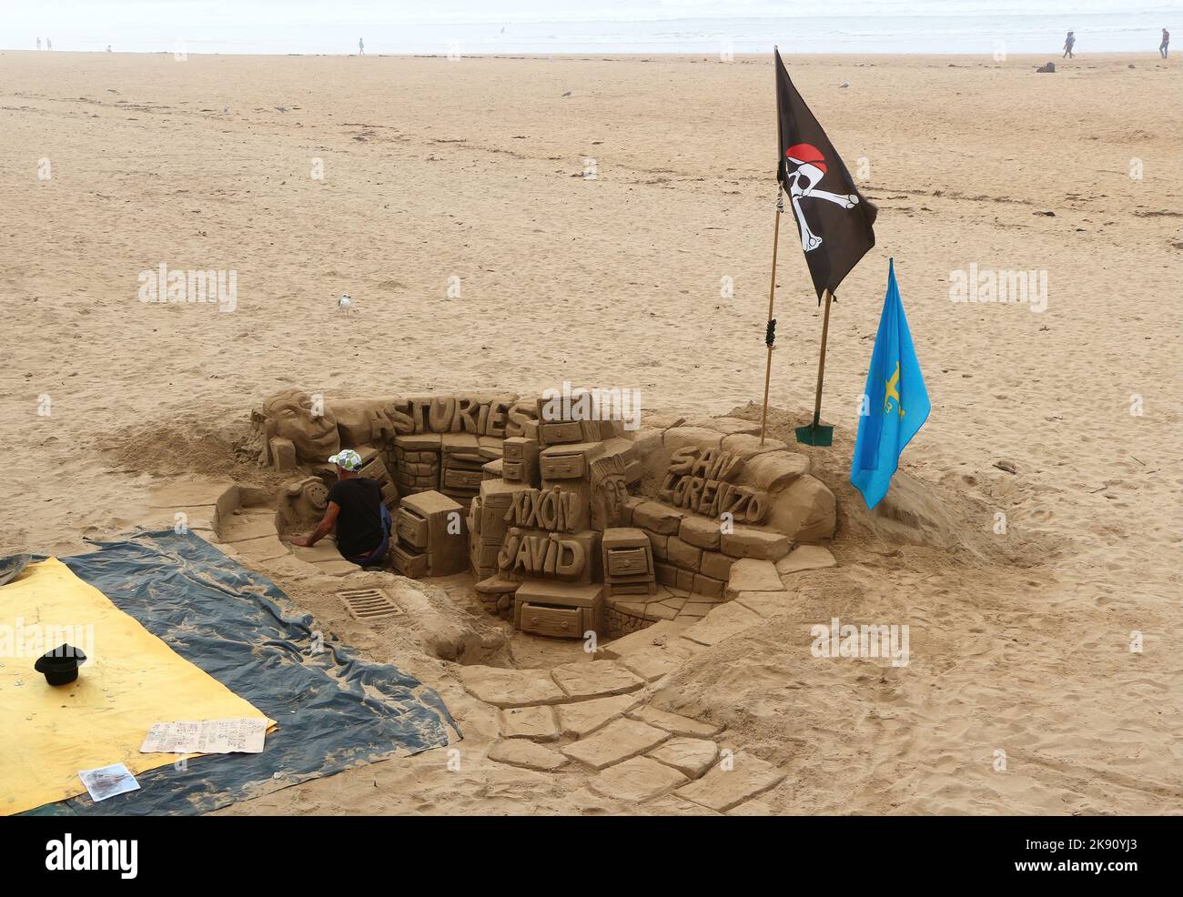Sand sculptor working creating chests of drawers on the beach Playa de ...