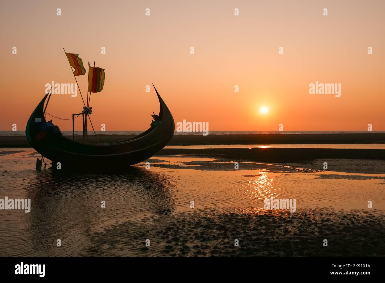 Scenic sunset seascape with beautiful traditional wooden fishing boat ...