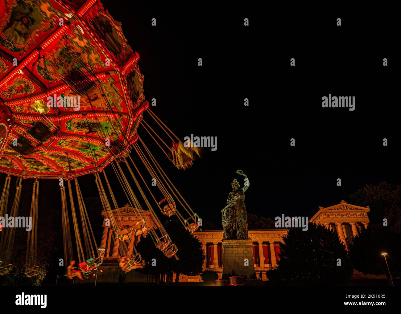 a close up shot from a carousel at Munich Oktoberfest by night, with ...