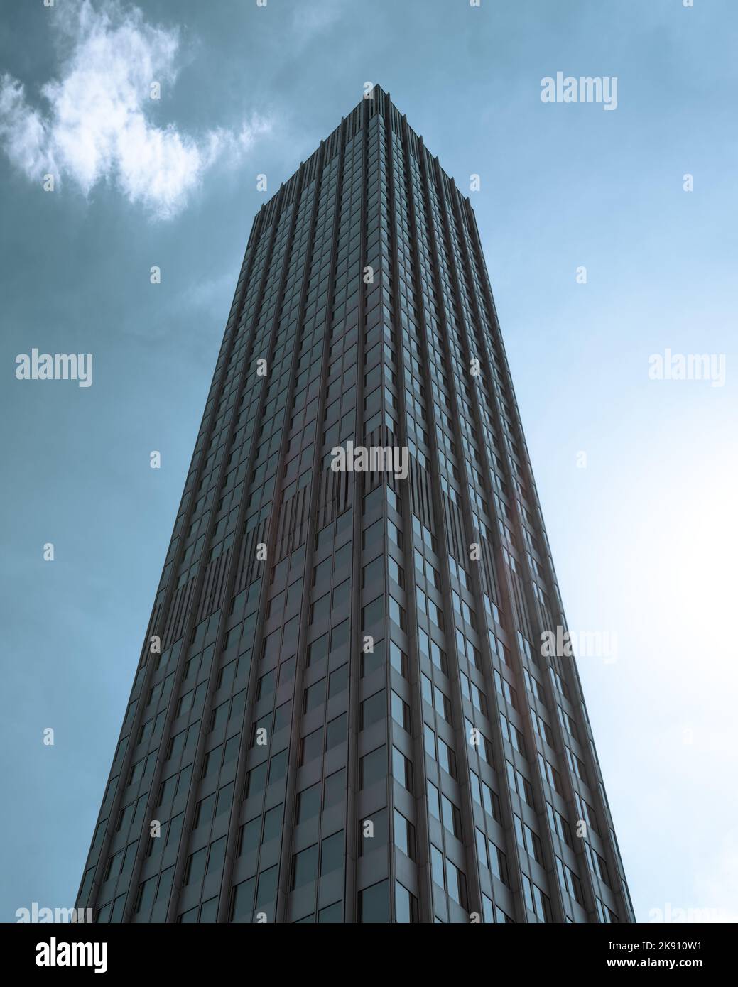 A low angle of a tall, modern building covered in glass with a sunny ...