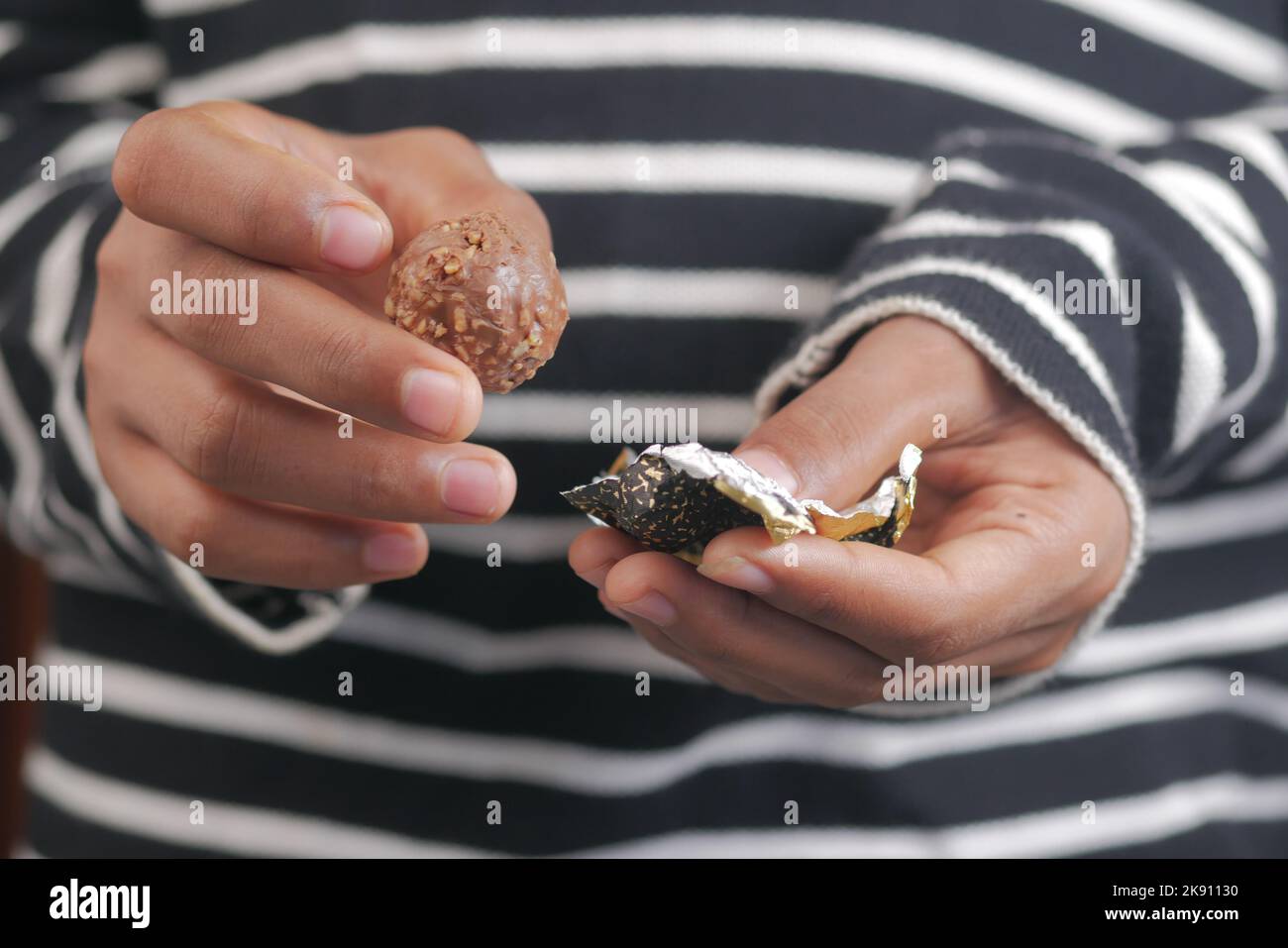 removing packet from a chocolate Stock Photo - Alamy