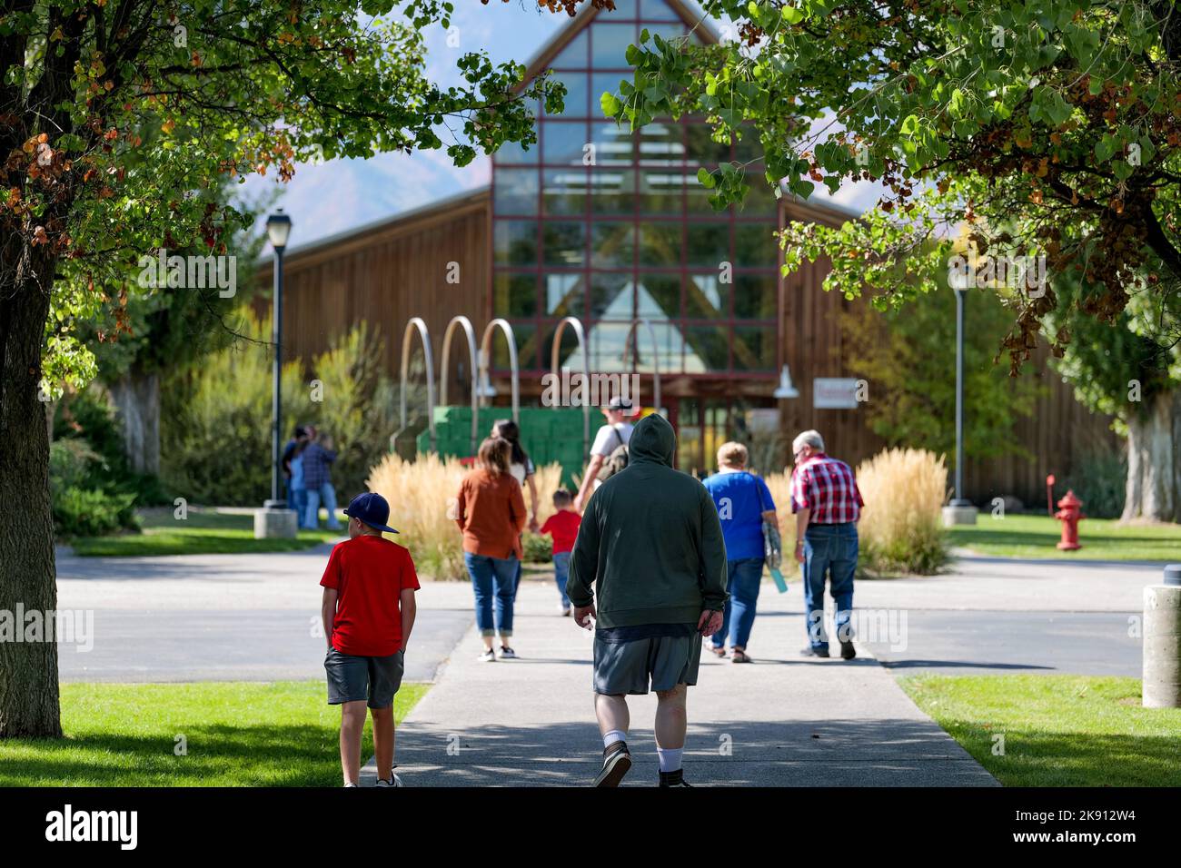 People walking to a country fairground event center building in ...
