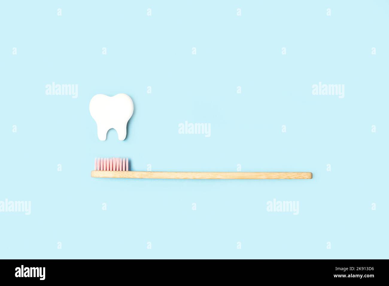 Bamboo wood toothbrush with pink brush bristles and a white wooden ...