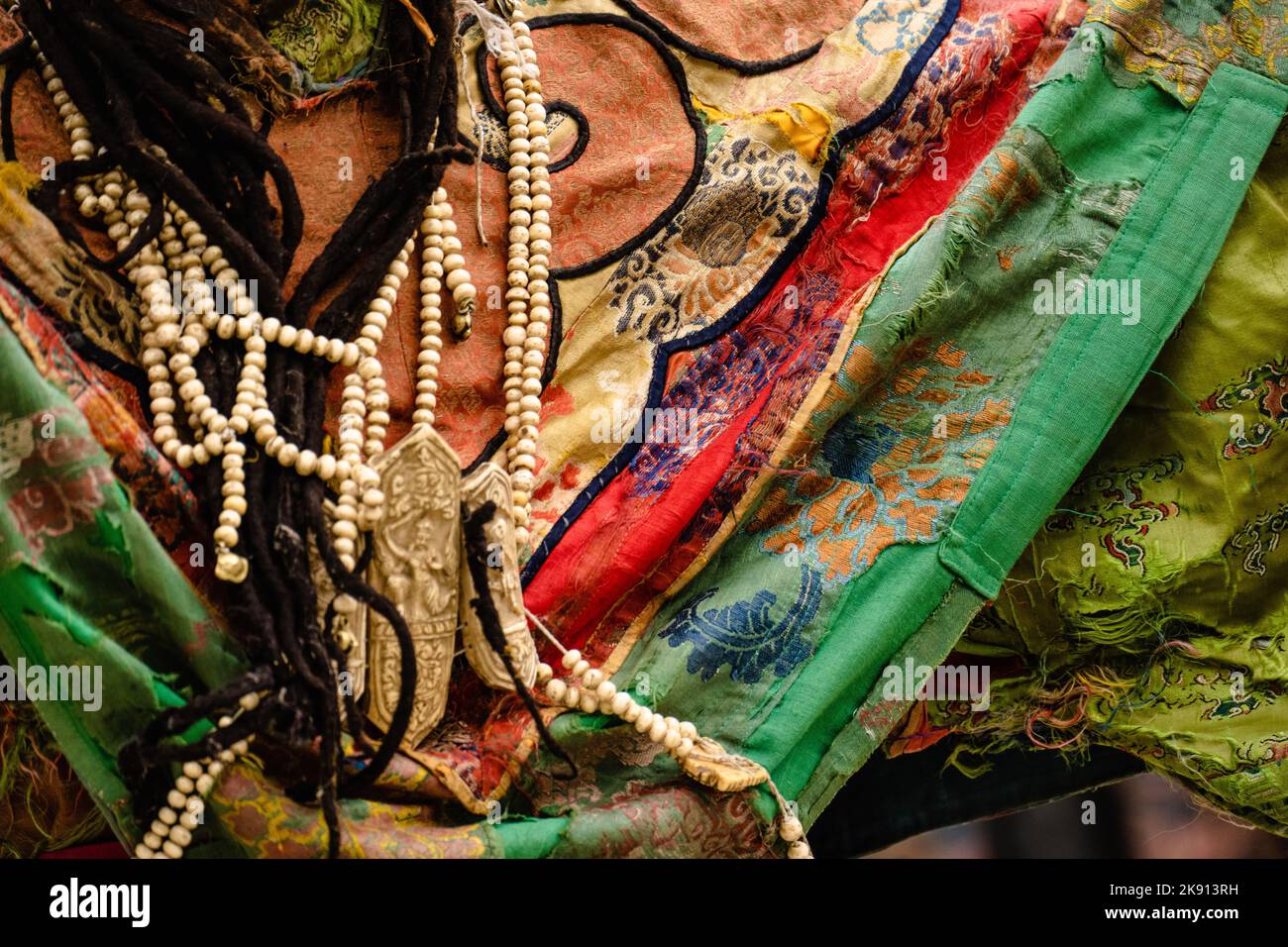 The ritual bone pendant on a Tibetan Buddhist dancer with colorful ...