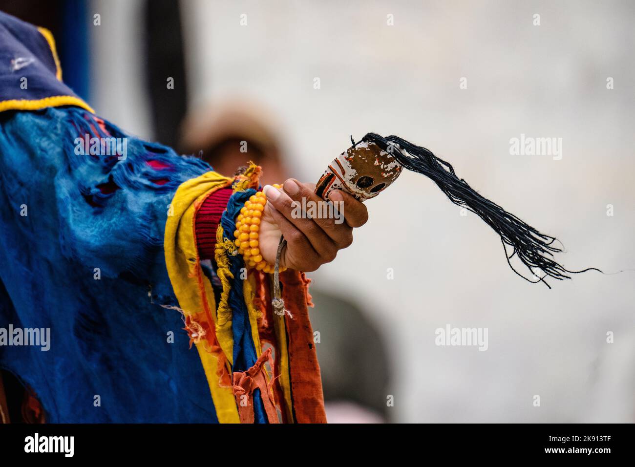 A Tibetan Buddhist ritual dancer holding a skull idol at Tiji Festival ...