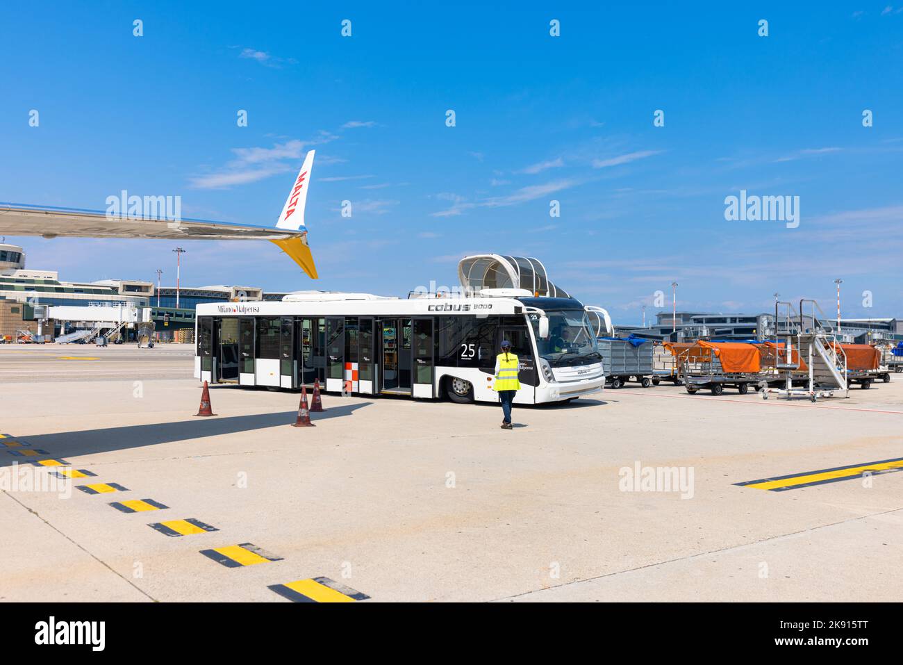 The airport Malpensa in Milan with a Cobus bus and a passenger plane ...